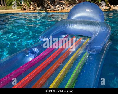 Colourful lilo in swimming pool Stock Photo - Alamy