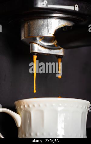 Espresso shot pouring out of an espresso maker Stock Photo - Alamy