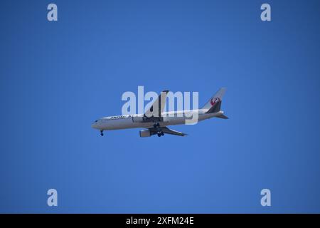 A Japan Airlines Boeing 767 with lowered landing gear on final approach ...