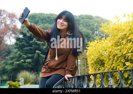 Strolling through the park with social media. Portrait of a handsome ...