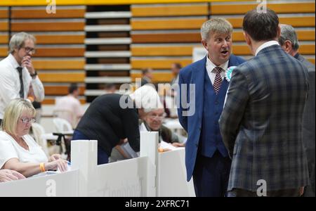 Agents from Reform UK look on as ballots are sorted at Clacton Leisure ...