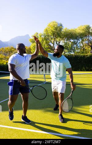 Diverse friends high fiving Stock Photo - Alamy