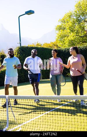 Playing tennis, group of diverse friends holding rackets and tennis ...