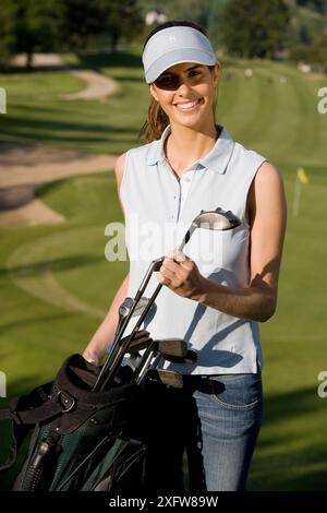 young woman playing golf Stock Photo - Alamy