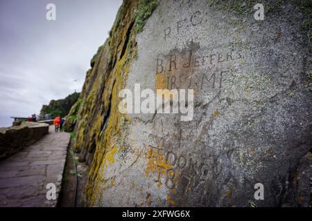 Small road with steps, graffiti on a wall and a latern in the town of ...