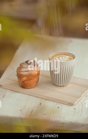 Cappuccino and cruffin on a minimalist coffee shop table. Coffee shop ...
