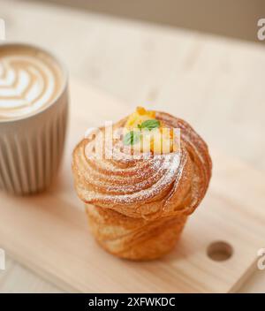 Cappuccino and cruffin on a minimalist coffee shop table. Coffee shop ...