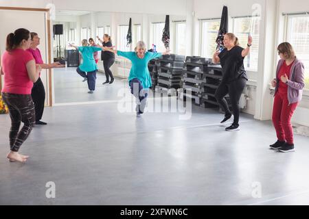 Female instructor dancing with students at dance studio Stock Photo - Alamy