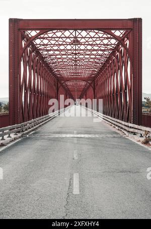 A bridge with a railing and a walkway. The railing is made of metal ...