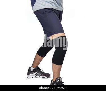 knee sleeve or knee cap shown on the models knee isolated on the white ...