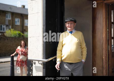 A woman walks in the sun in London, Tuesday, June 23, 2026, as a heat ...
