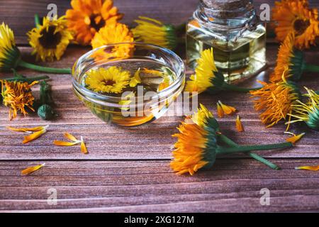 Fresh and dried calendula flowers on wooden background Stock Photo - Alamy