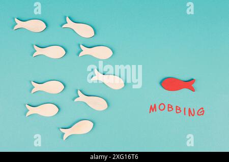 Group of fish mobbing a victim, social conflict, bullying one ...