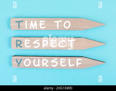 The words time to respect yourself are standing on wooden arrows ...