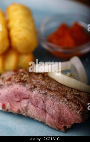 Slice of steak on a blue plate Stock Photo - Alamy