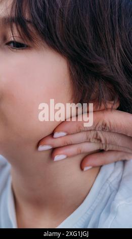 Paediatric endocrinologist , examining swollen lymph nodes of a young ...