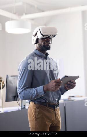 Businessman holding high tech tablet on background with copyspace Stock ...