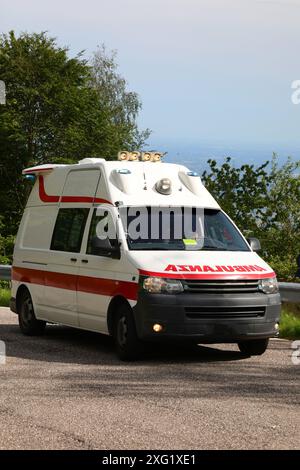 while Ambulance van with the text AMBULANZA written backwards in ...