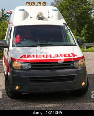 white emergency van with the word AMBULANZA spelled backward so that it ...