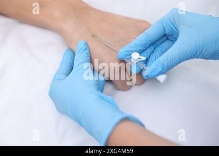 Nurse inputting catheter for IV drip in patient hand, closeup Stock ...