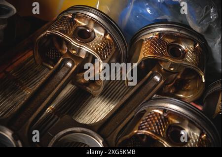 Old used engine pistons close up. Four pistons from an old disassembled ...
