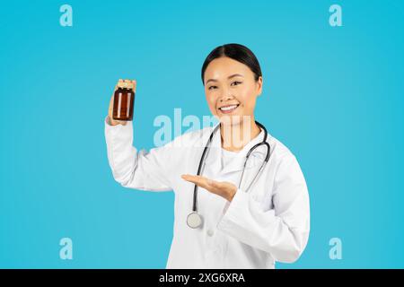 Asian woman patient holding medication pill bottle reading instructions ...