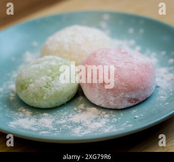 Different color delicious Japanese mochi on the blue plate Stock Photo ...