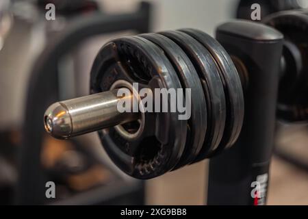 Gym equipment is neatly stacked in a fitness center unaltered. Various ...