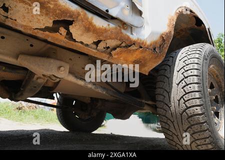Deep rust on the body of a gray old car. Rust and corrosion hole on old ...