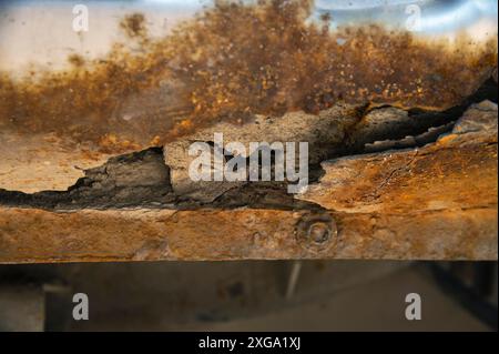 Deep rust on the body of a gray old car. Rust and corrosion hole on old ...