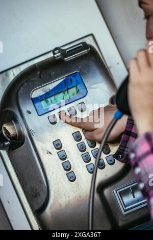 Young woman is talking with a classical old fashioned pay phone Stock ...