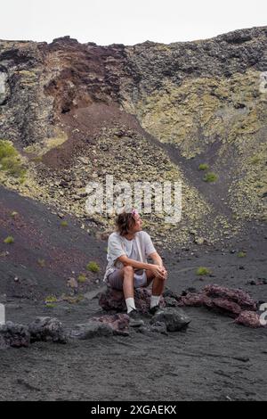 Black rock volcanic formation on sand beach. Square stones on the coast ...