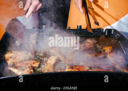 closeup of frying meat process. outdoor food cooking background. view ...