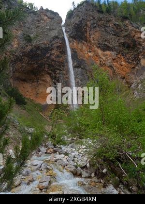 The picturesque waterfall Rinka falls from a steep ledge. Slovenia ...