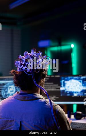 Engineer with EEG headset on programming brain transfer into computer ...