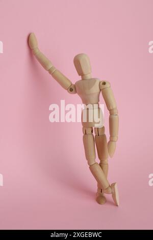 Wooden human model on pink background, space for text. Mini mannequin ...