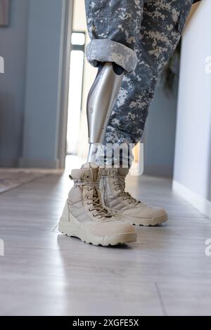 Military soldier personnel with prosthetic leg sitting on chair ...