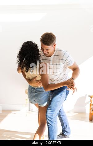 Young couple dancing embrace passion romance on dark red light ...