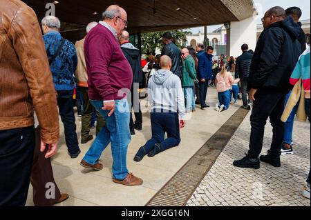 A middle aged man crawls on his knees through the chapel of apparitions ...
