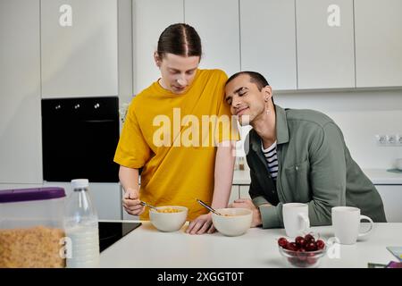 A young gay couple enjoys breakfast together in a modern apartment ...