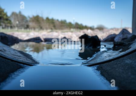 Inside a circular concrete drainage culvert with a trickle of water ...