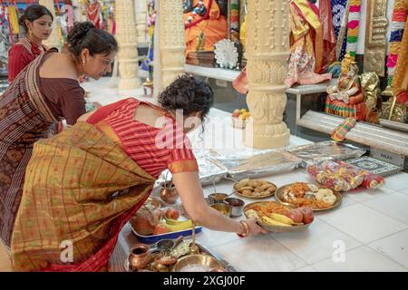 Worshippers at the Wilton Hindu temple prepare food offerings for their ...