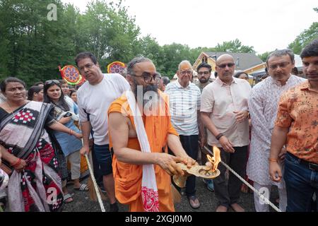 Swami Balgopal a priest & monk, leads a statue of the Hindu god Balaram ...