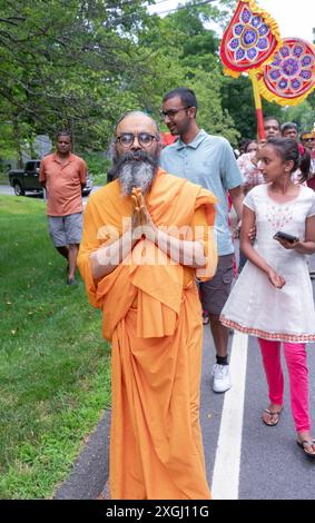 Swami Balgopal a priest & monk, leads a statue of the Hindu god Balaram ...