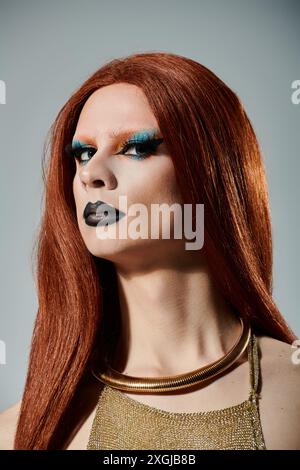 A drag diva with long red hair and dramatic makeup stares intensely at ...
