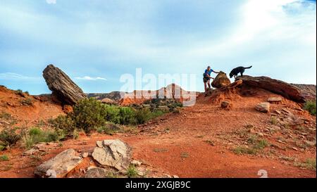 A single woman and her black lab hiking in Palo Duro Canyon State Park ...