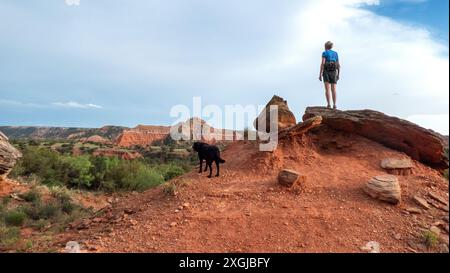 A single woman and her black lab hiking in Palo Duro Canyon State Park ...