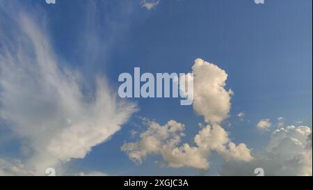 Clouds drift across sky as sun sets, casting warm glow over tranquil ...