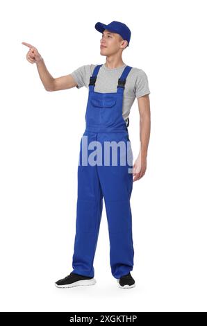 Auto mechanic pointing at something on white background Stock Photo - Alamy