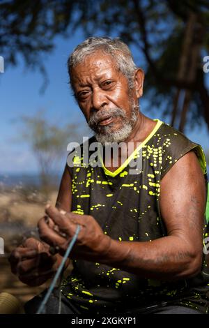 Fisherman mending a fish net on the beach, Dili, Timor-Leste Stock ...
